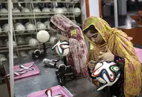 Egy pakisztáni gyár két alkalmazottja az utolsó simításokat tette fel több hivatalos futballlabdán a brazíliai világbajnokságon